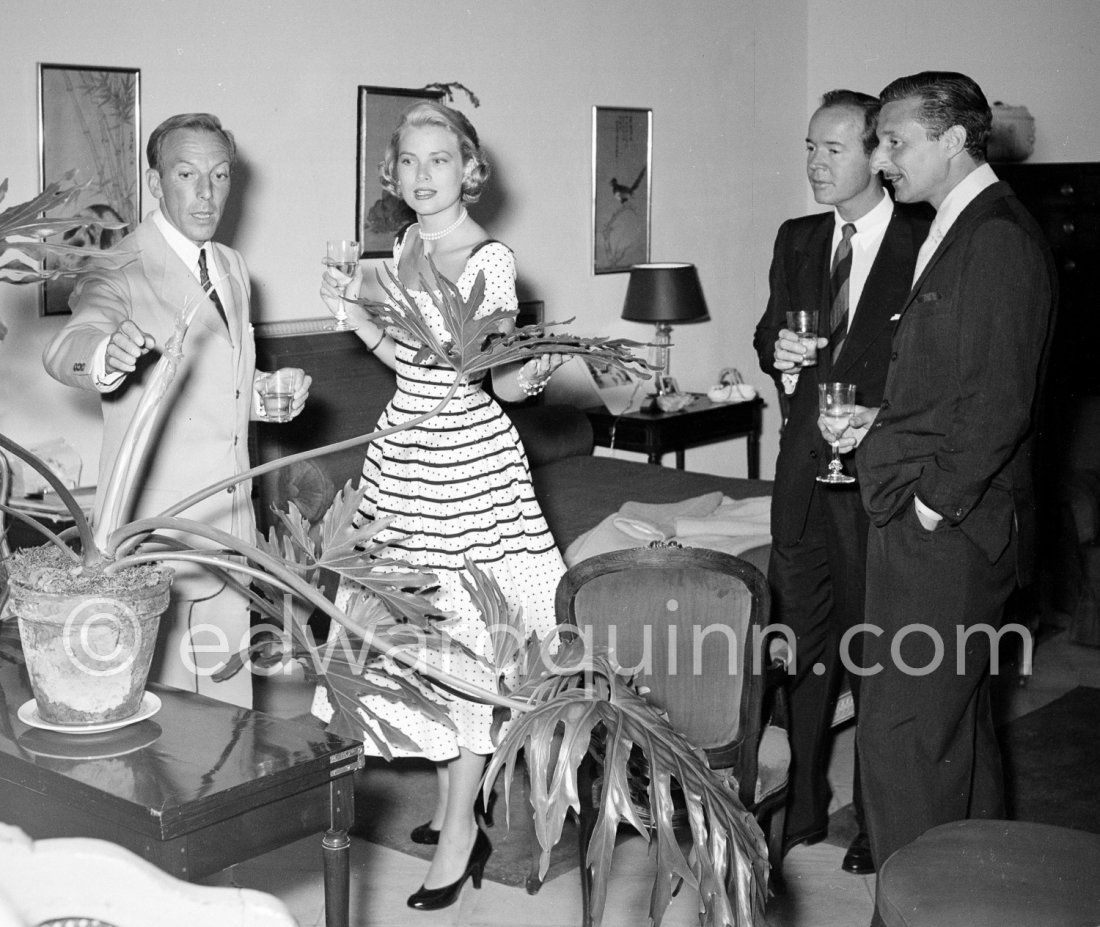 Grace Kelly at a cocktail party given by Jacques Fath (left) at his ...